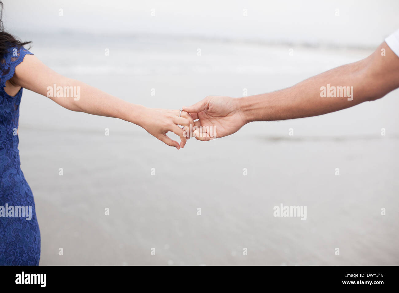 Couple holding hand on beach hi-res stock photography and images - Alamy