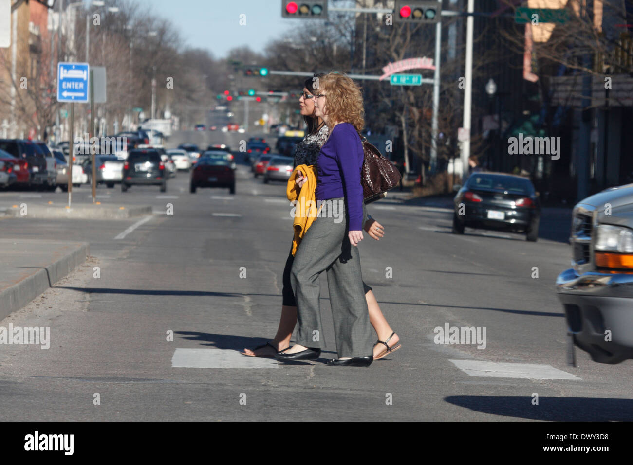 Two women crossing a street Stock Photo - Alamy
