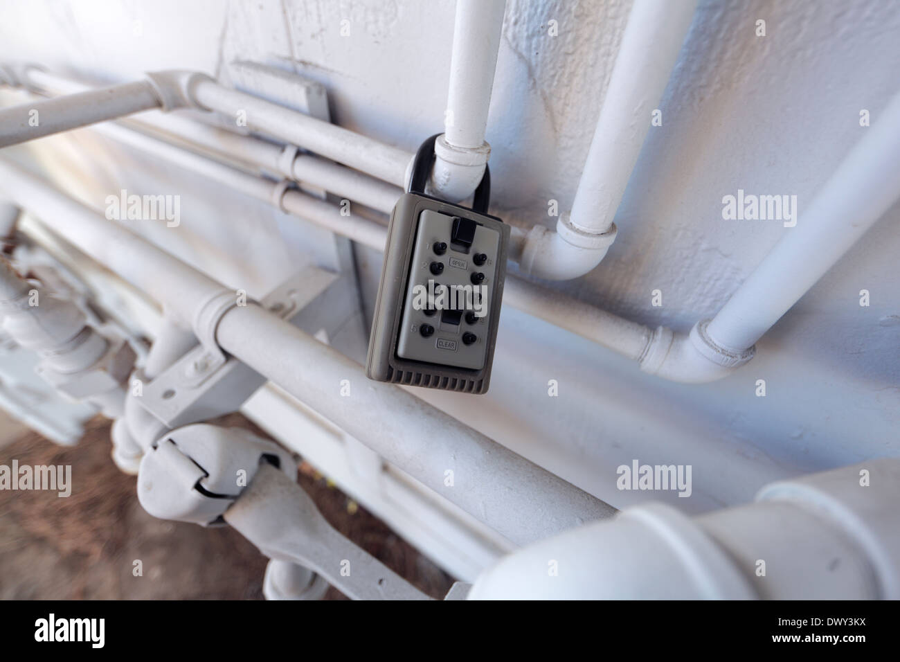Key lockbox attached to pipes Stock Photo - Alamy