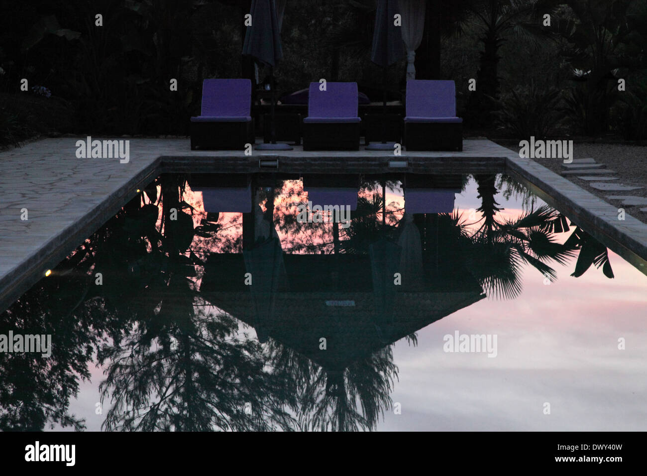 Sunset over Ibiza swimming pool Stock Photo - Alamy