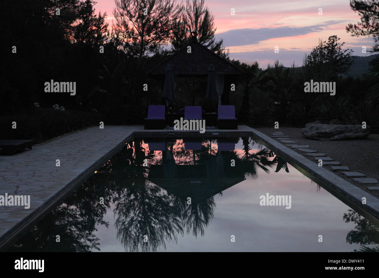 Sunset over Ibiza swimming pool Stock Photo - Alamy