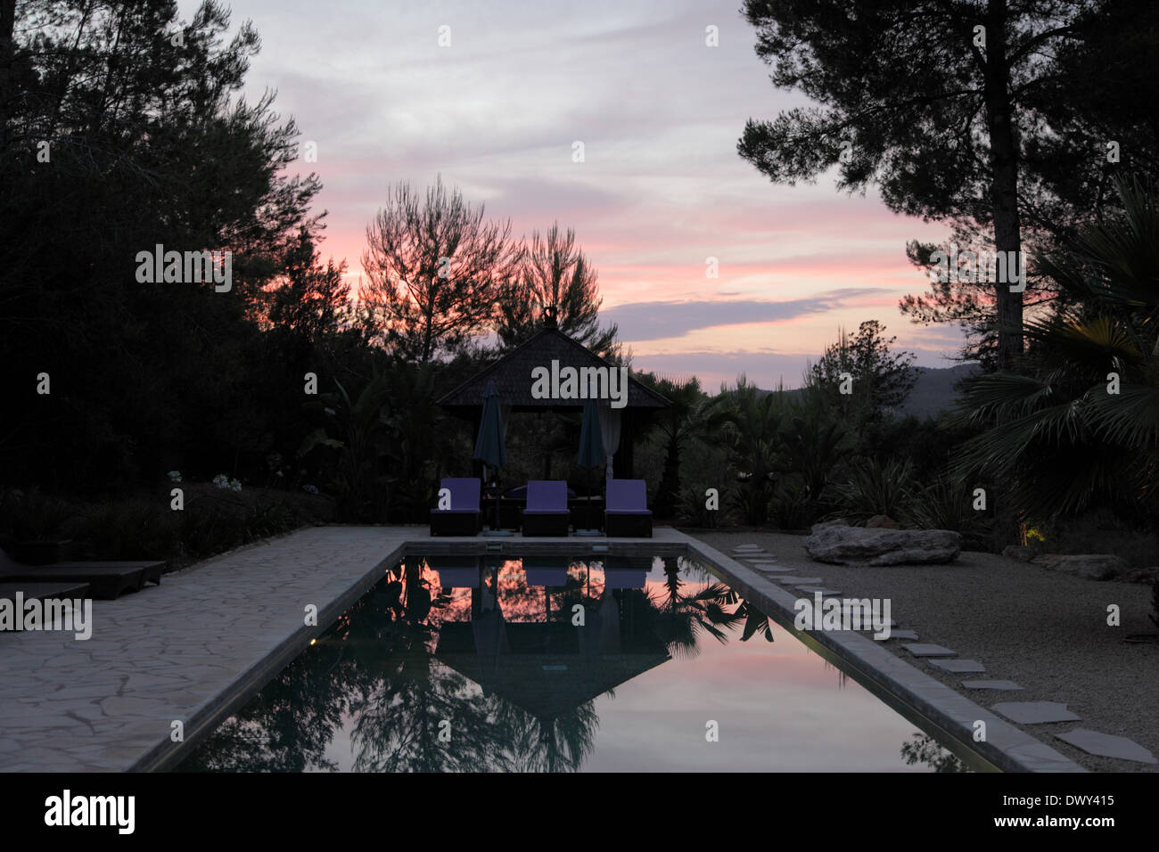Sunset over Ibiza swimming pool Stock Photo - Alamy