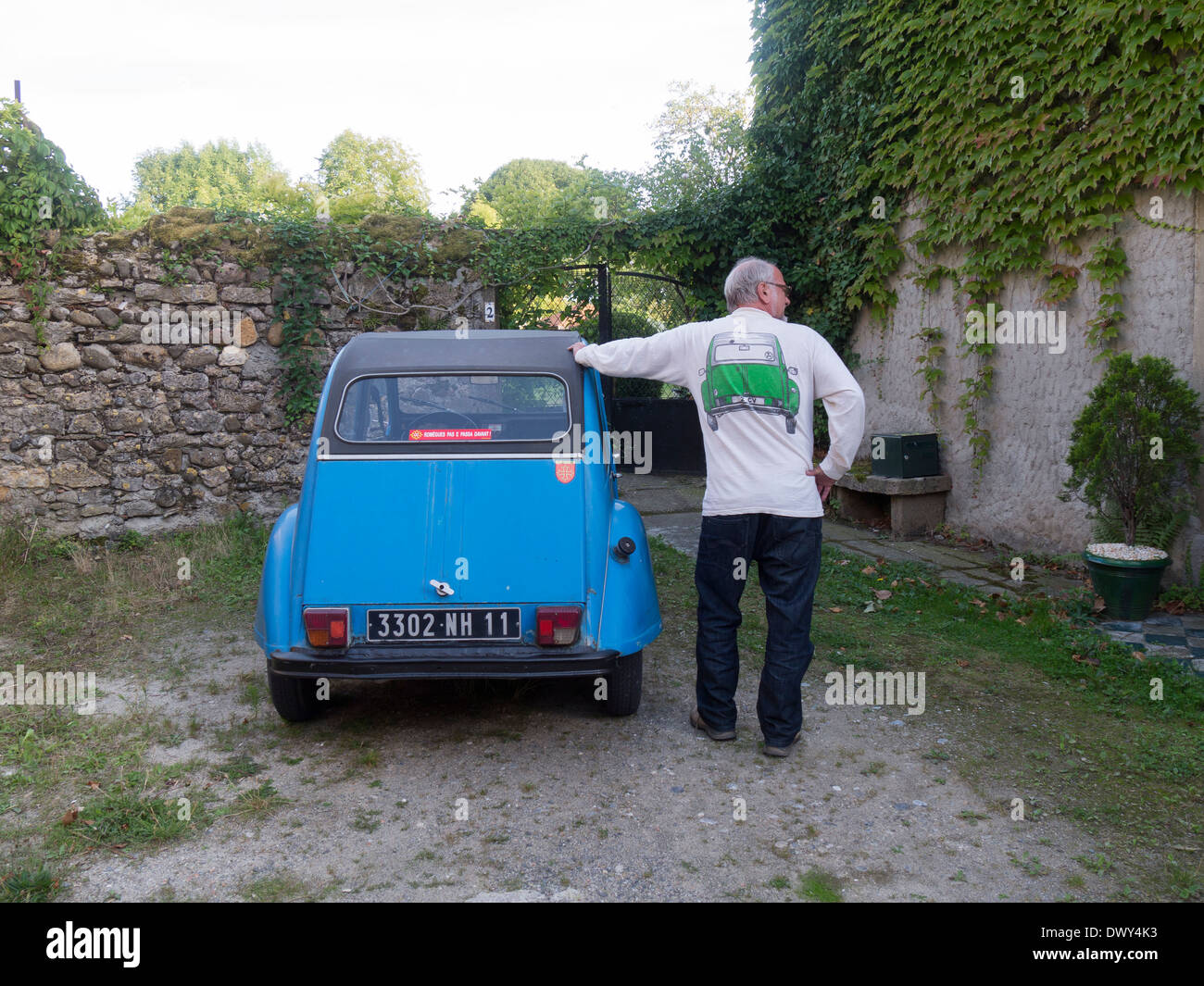 A proud Citroen 2CV owner beside his car Stock Photo - Alamy