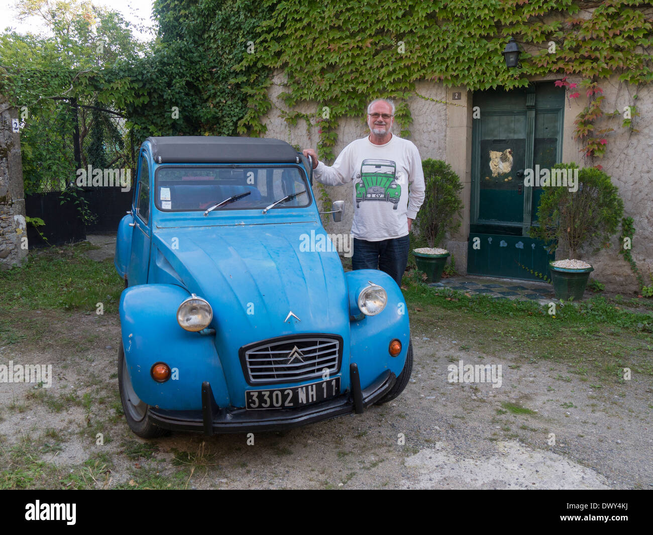 A proud Citroen 2CV owner beside his car Stock Photo - Alamy