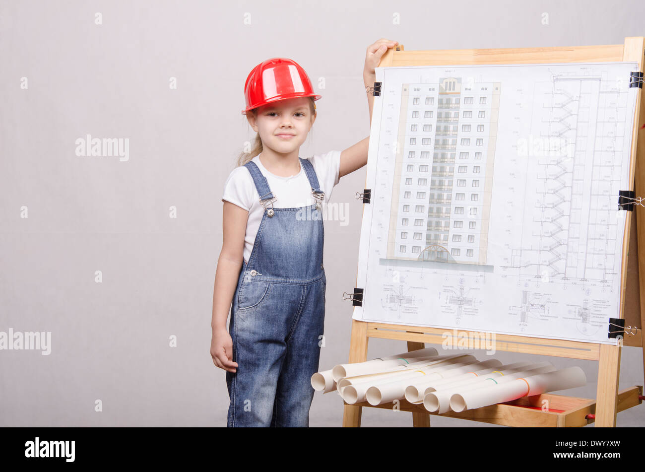 Girl Builder, architect, stands at the blackboard with the drawing of ...