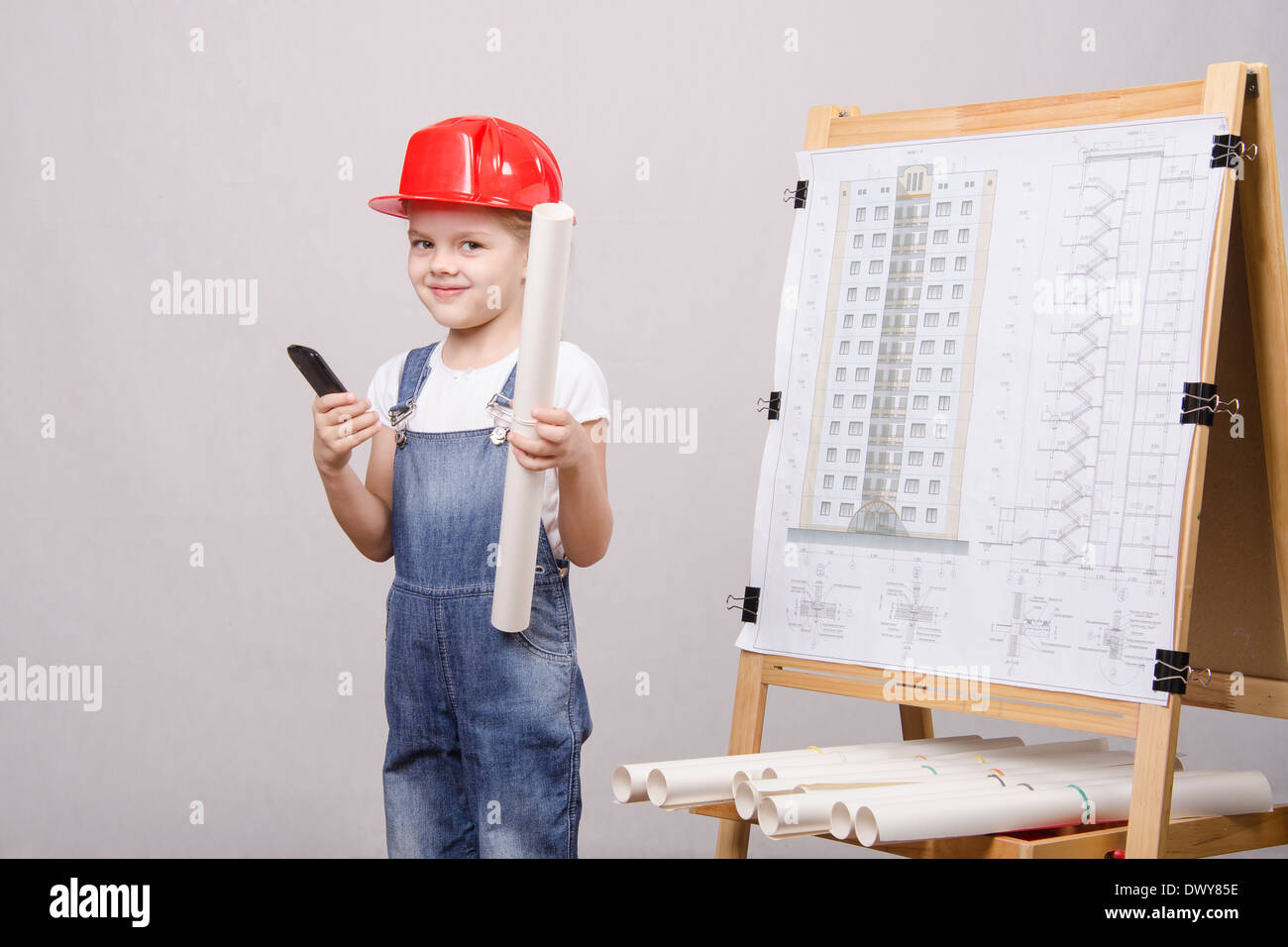 Girl playing Builder talking on the phone behind the blackboard with a ...