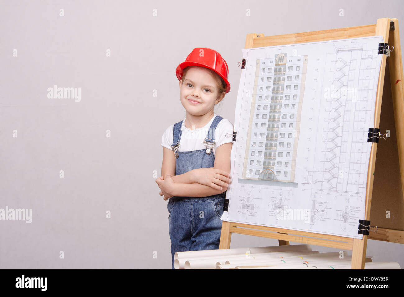 Girl Builder, architect, stands at the blackboard with the drawing of ...