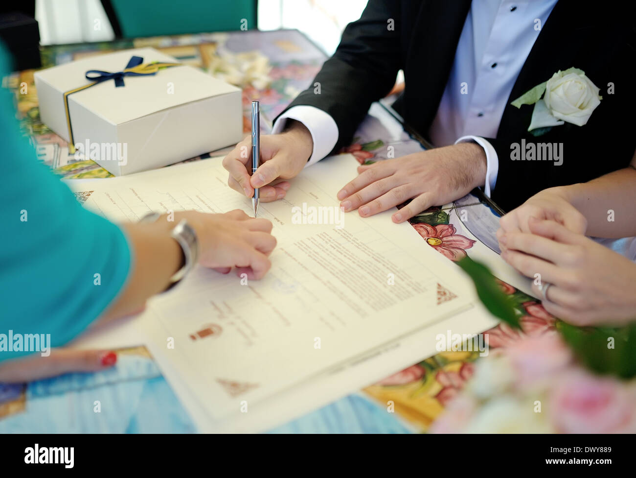 Hands newlyweds who sign the marriage certificate Stock Photo - Alamy