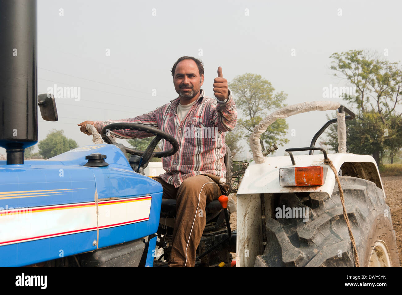 1 Indian Farmer Driving Tractor Stock Photo - Alamy