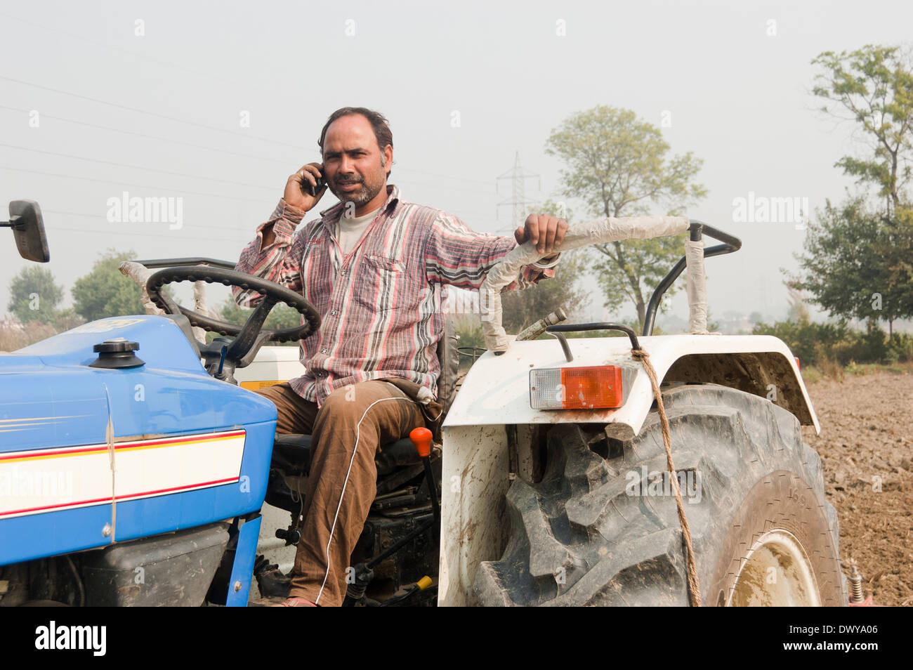 1 Indian Farmer Driving Tractor and talking Stock Photo - Alamy
