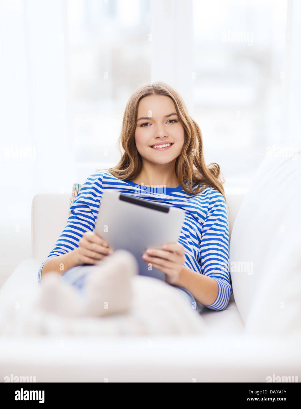 smiling teenage girl with tablet pc at home Stock Photo - Alamy