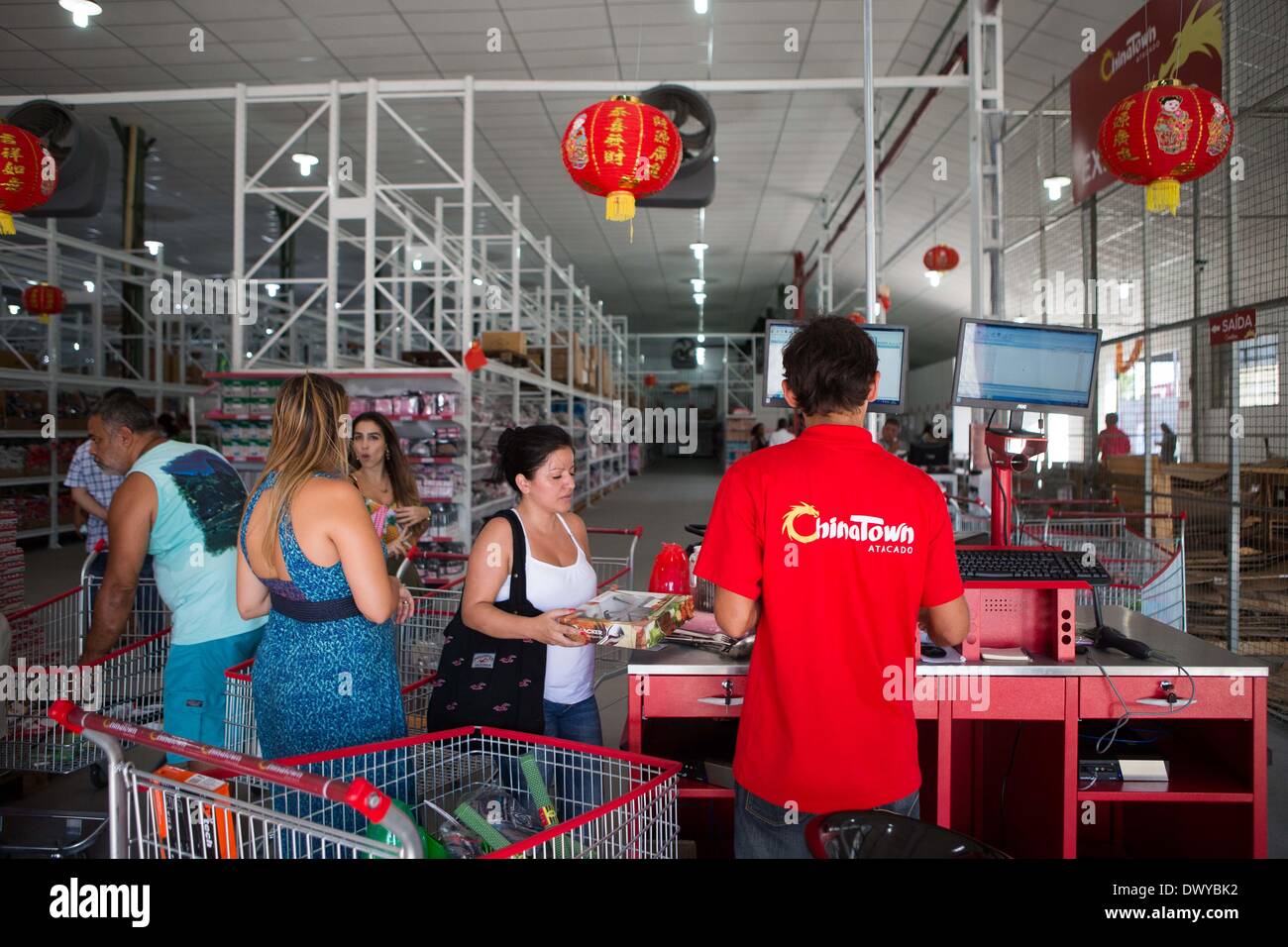 Rio De Janeiro, Brazil. 14th Mar, 2014. Customers check out in the ...
