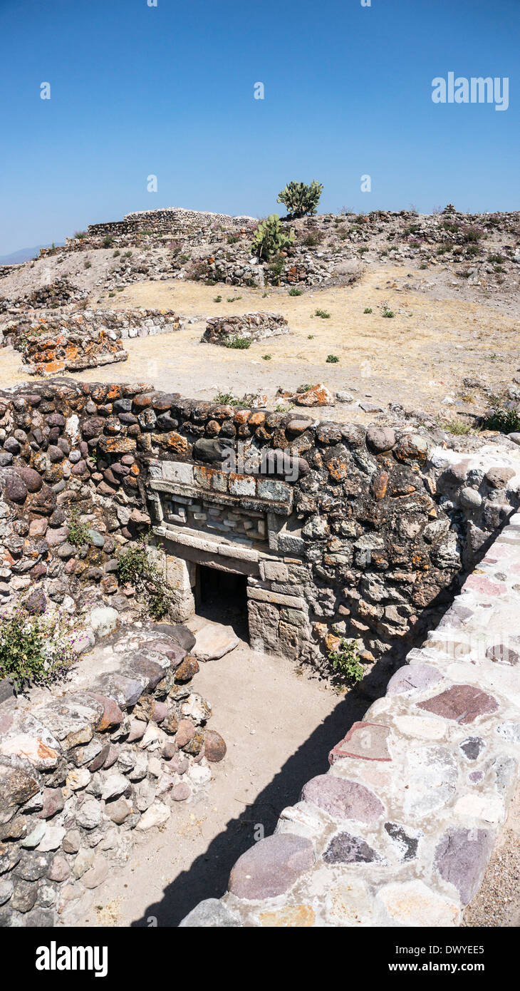 sunken entrance to tomb with stone mosaic frieze above lintel on hill ...