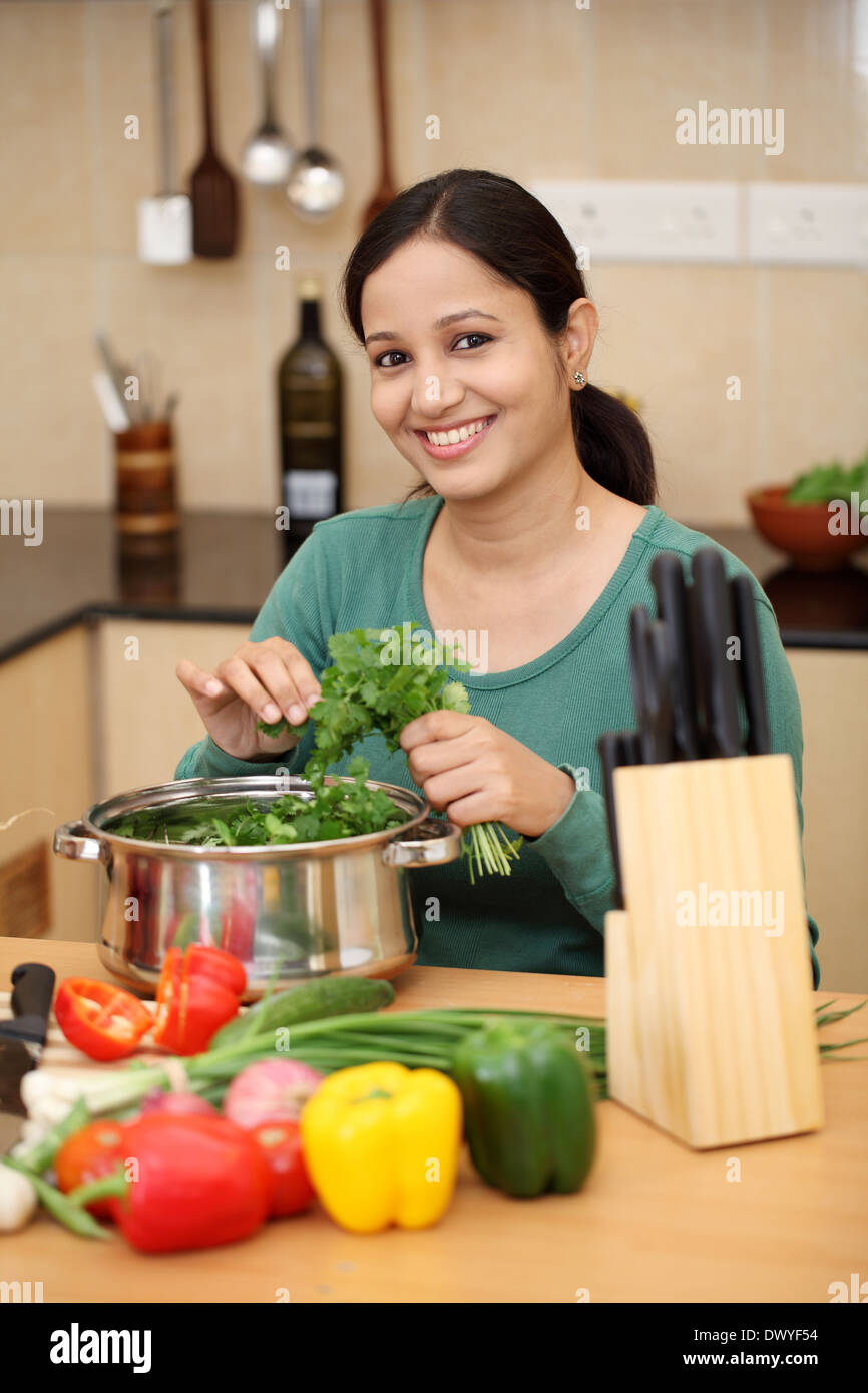 Happy smiling young Indian woman in kitchen Stock Photo - Alamy