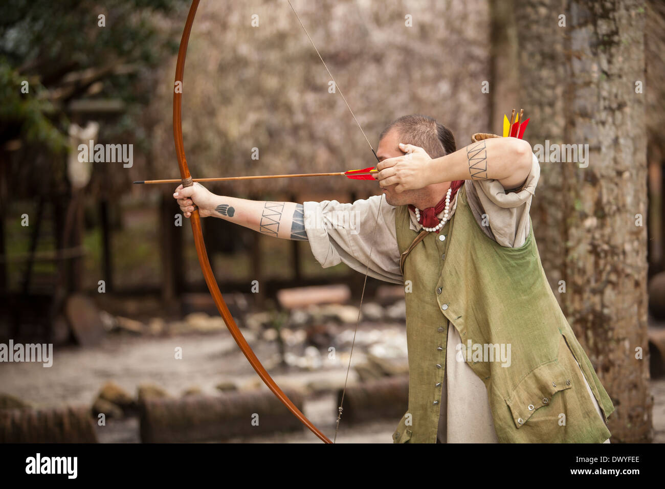 A Timucua native reenactor fires an arrow in St. Augustine Fountain ...
