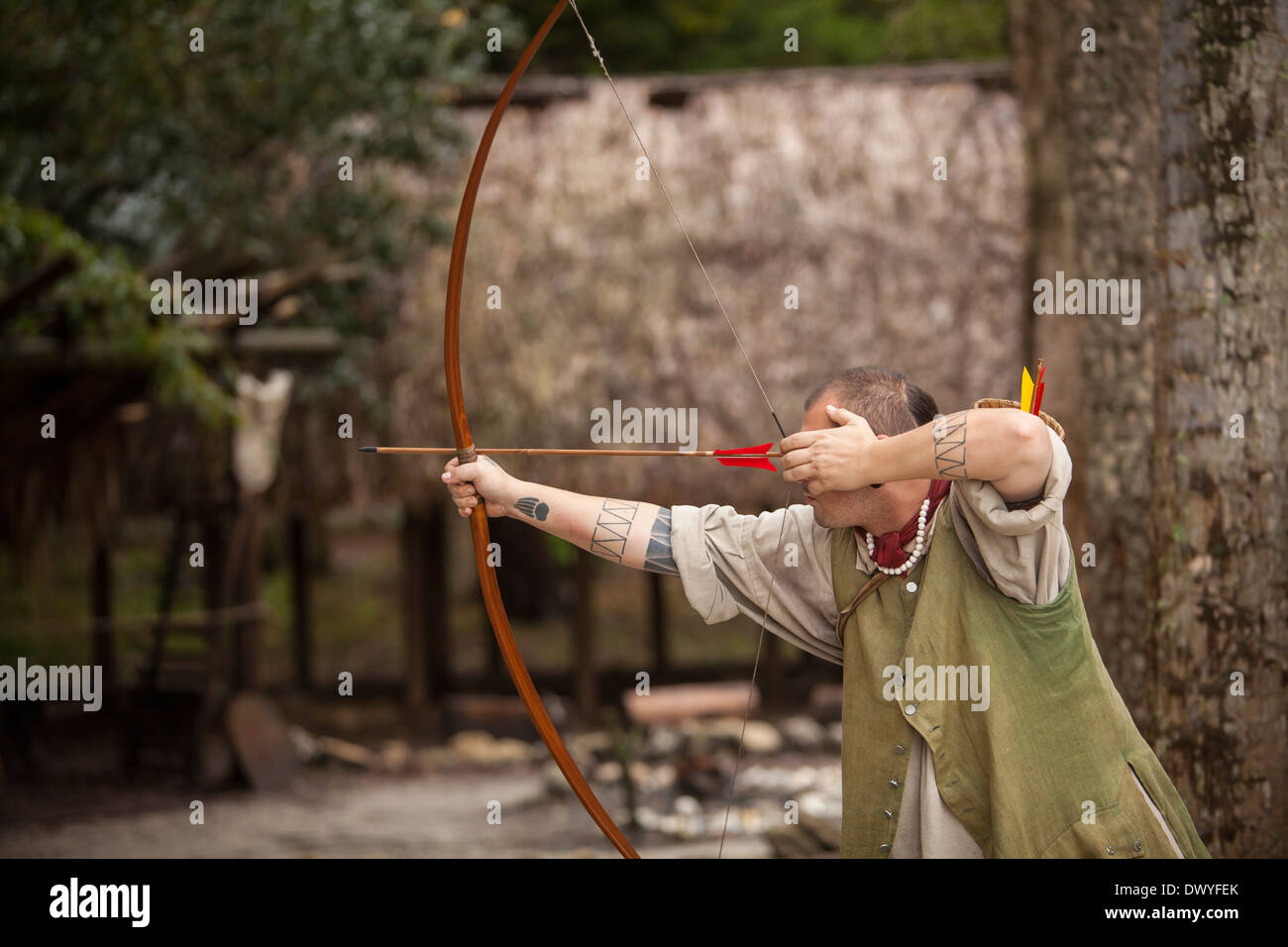 A Timucua native reenactor fires an arrow in St. Augustine Fountain of ...