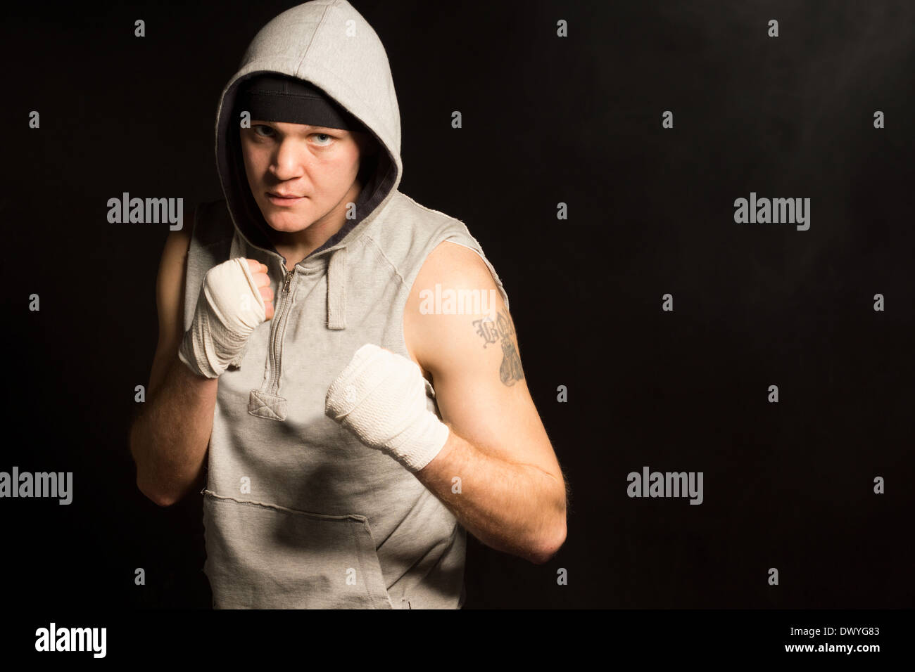 Intense determined young boxer squaring off at the camera with his ...