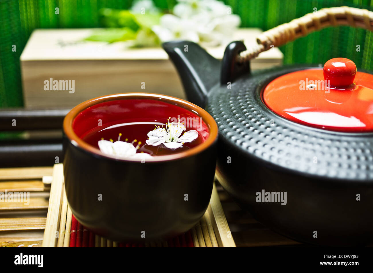 Green tea in a ceramic cup, ceramic teapot, Sakura Stock Photo - Alamy