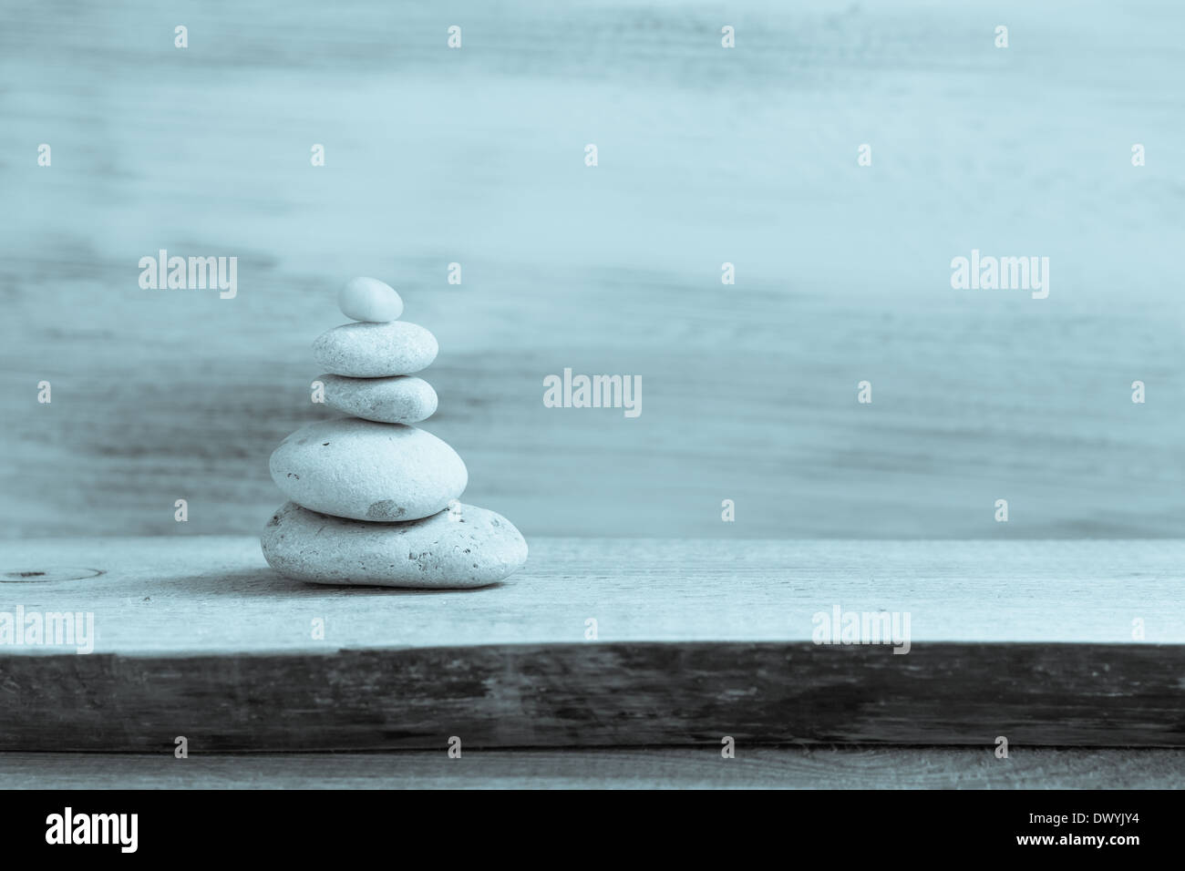Pyramid of zen stones on a wooden board Stock Photo - Alamy