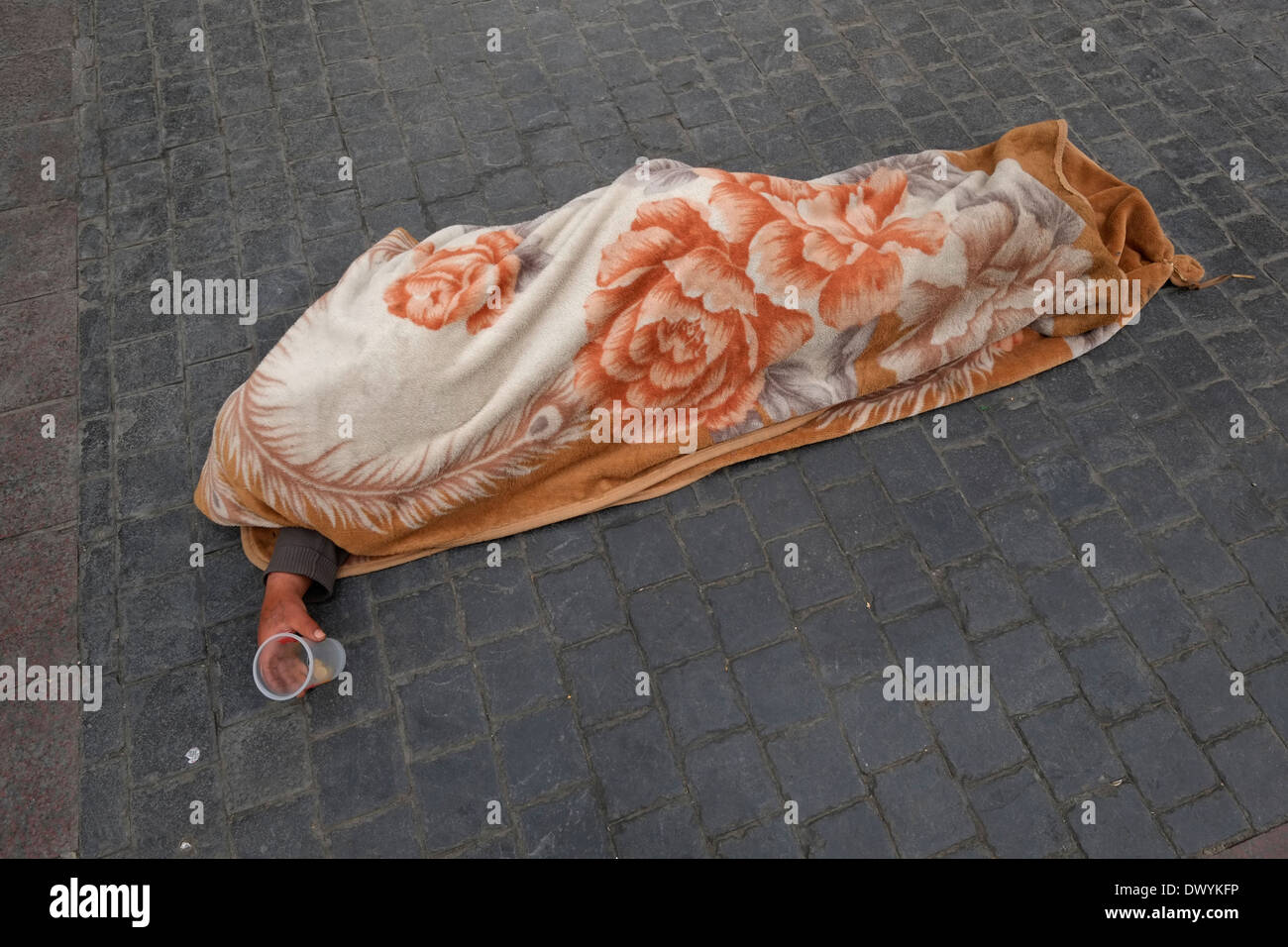 A homeless person sleeping in the street in downtown West Jerusalem ...