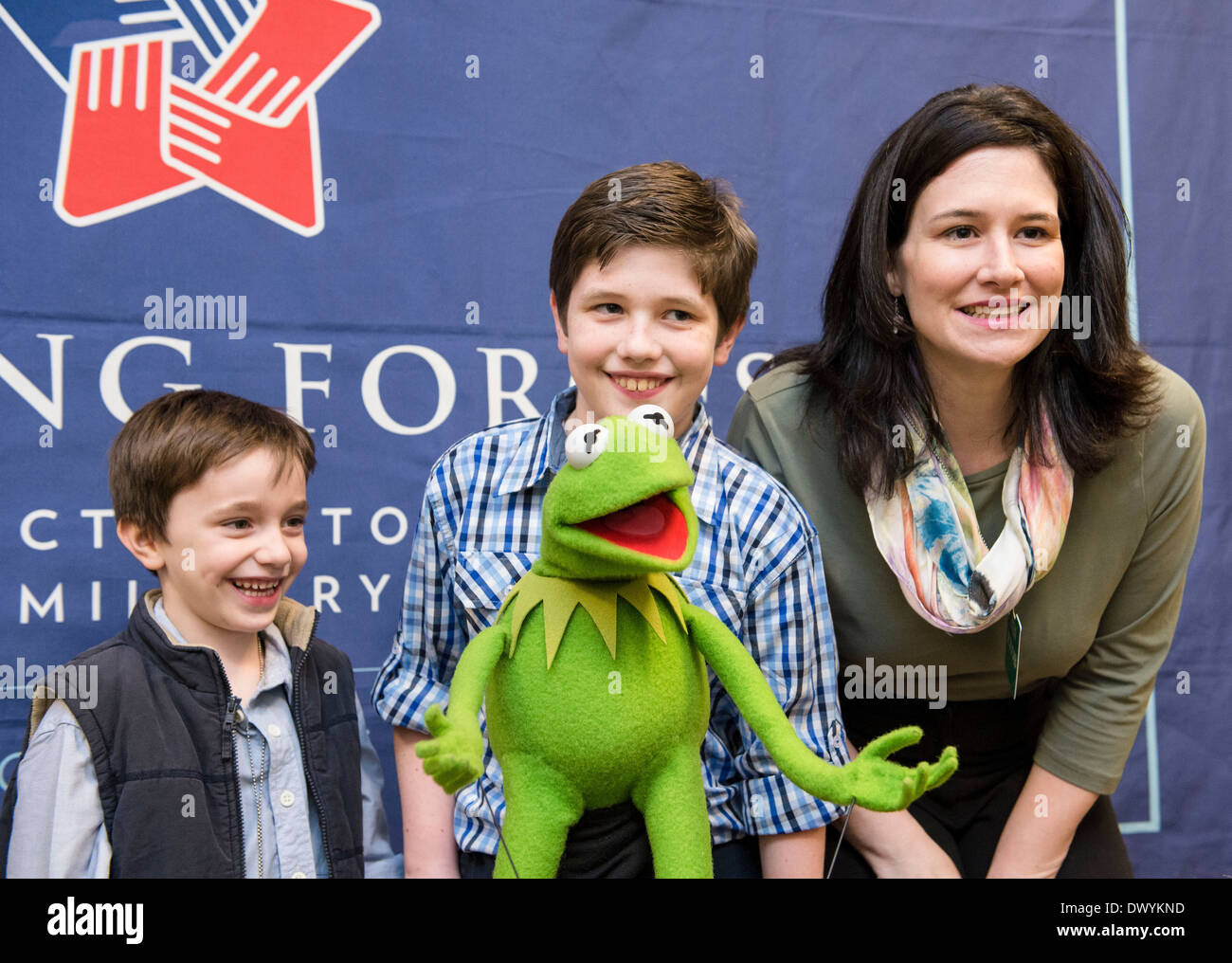 Military families pose with Kermit the Frog during a movie screening of ...