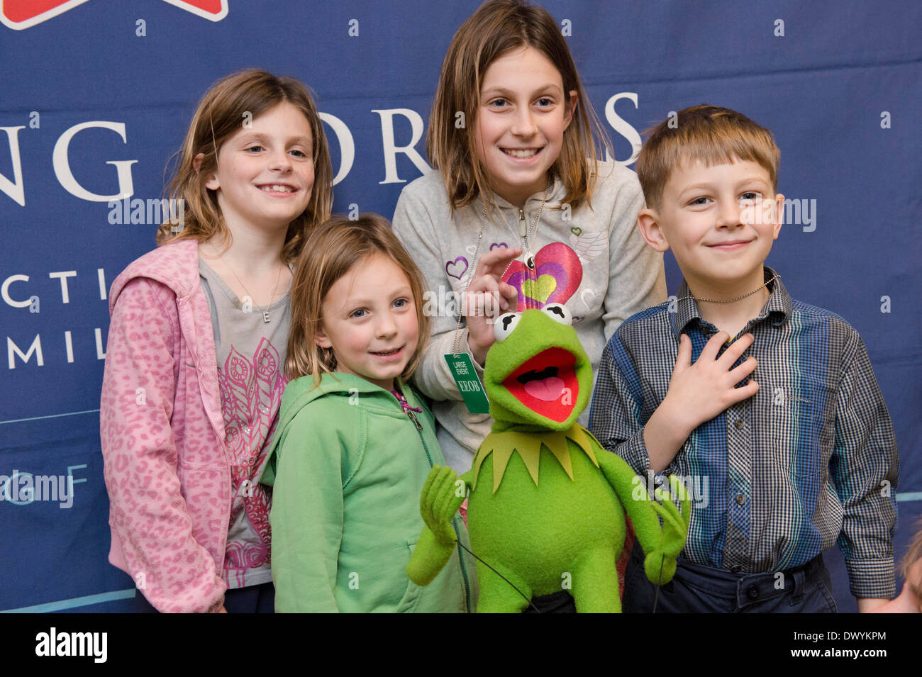Military children pose with Kermit the Frog during a movie screening of ...