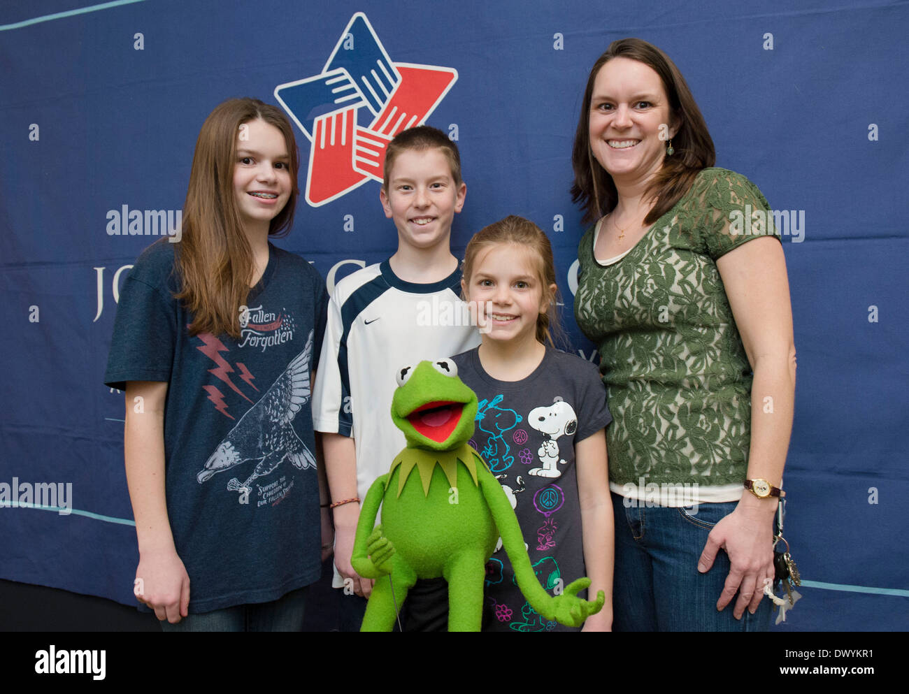 Military families pose with Kermit the Frog during a movie screening of ...
