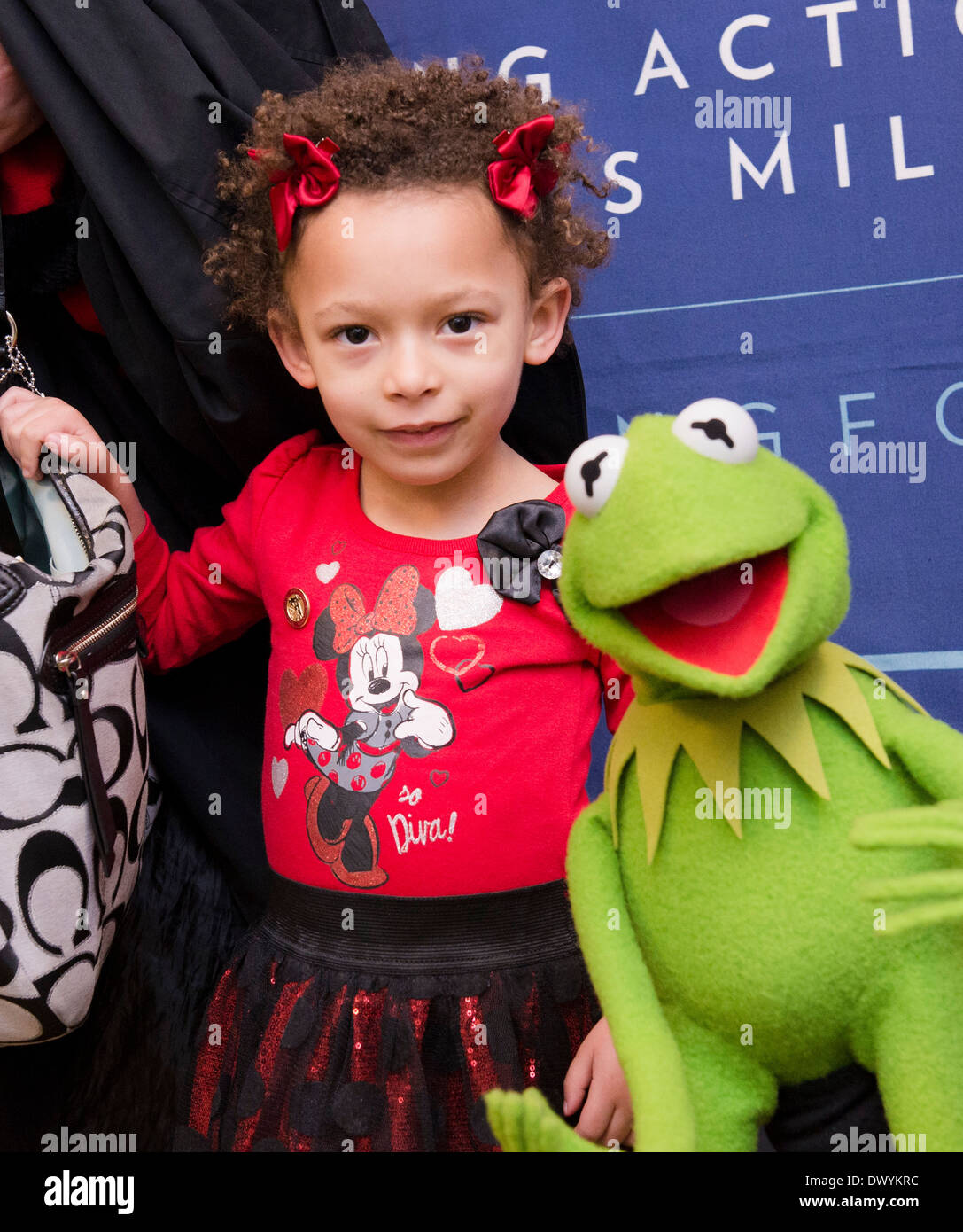 Military families pose with Kermit the Frog during a movie screening of ...