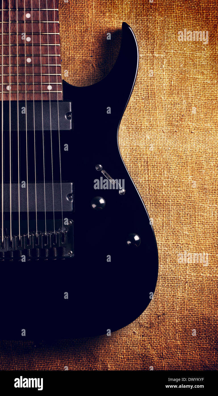 black electric eight-string guitar, on canvas background Stock Photo ...