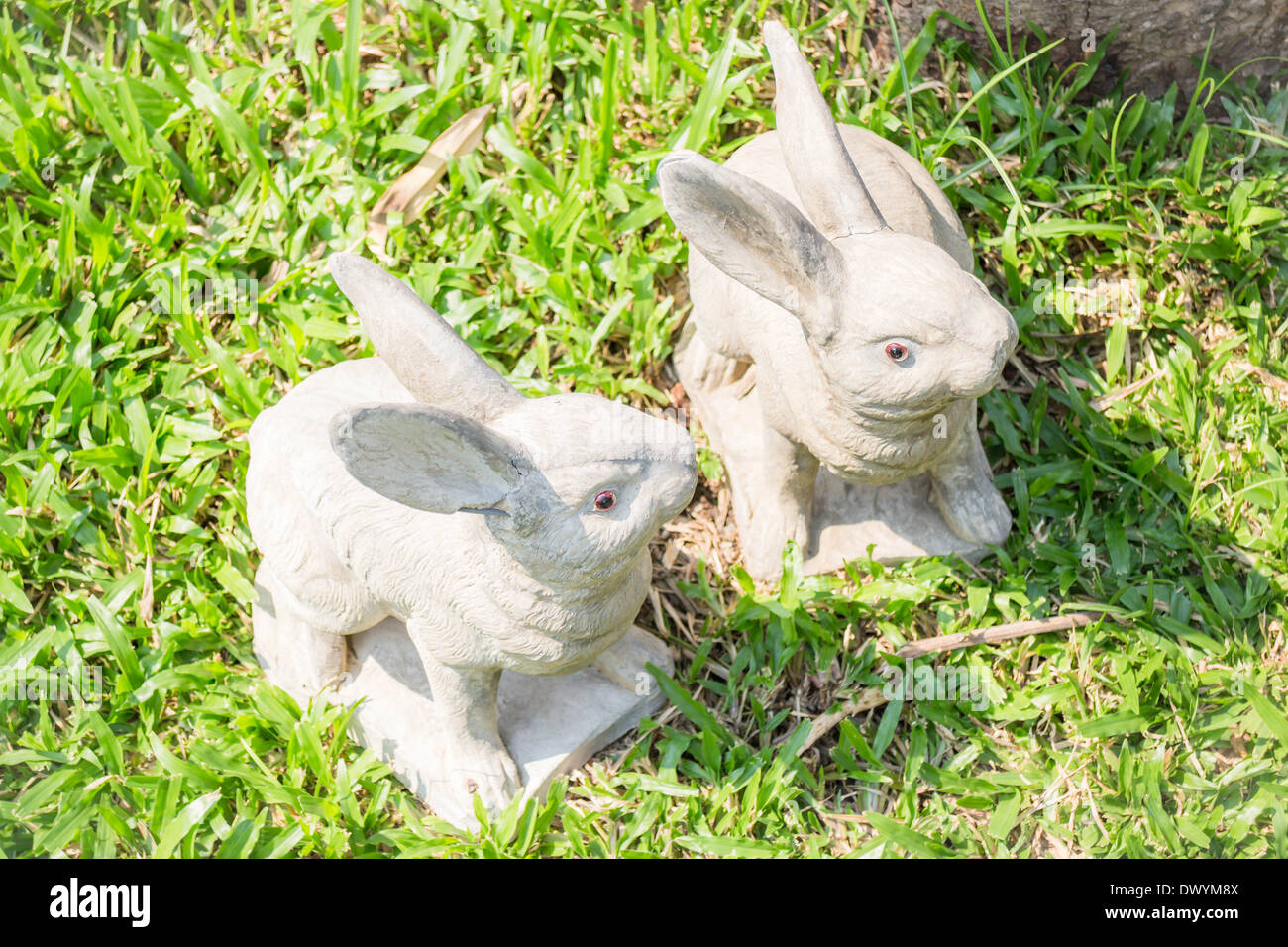 Twin rabbits of plaster decorated in green grass, stock photo Stock ...