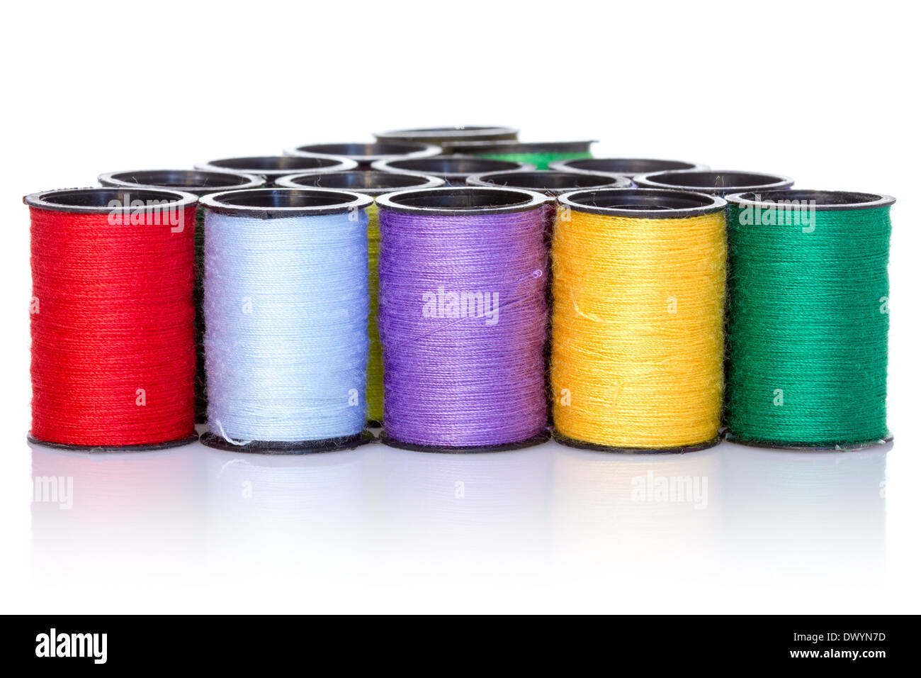 Colorful bobbins with reflection on white background Stock Photo - Alamy