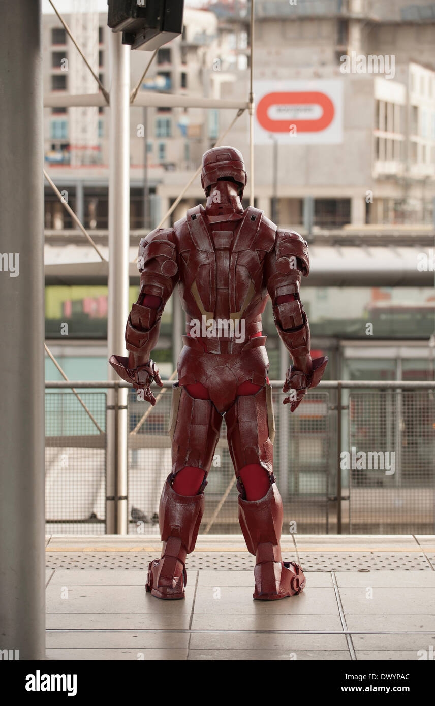 ExCel, London UK. 15th March, 2014. A visitor dressed as Iron Man waits ...