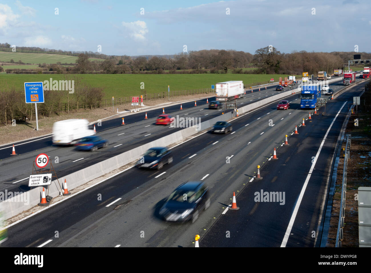 Traffic passing a coned off area on the M25 motorway in Surrey, UK ...