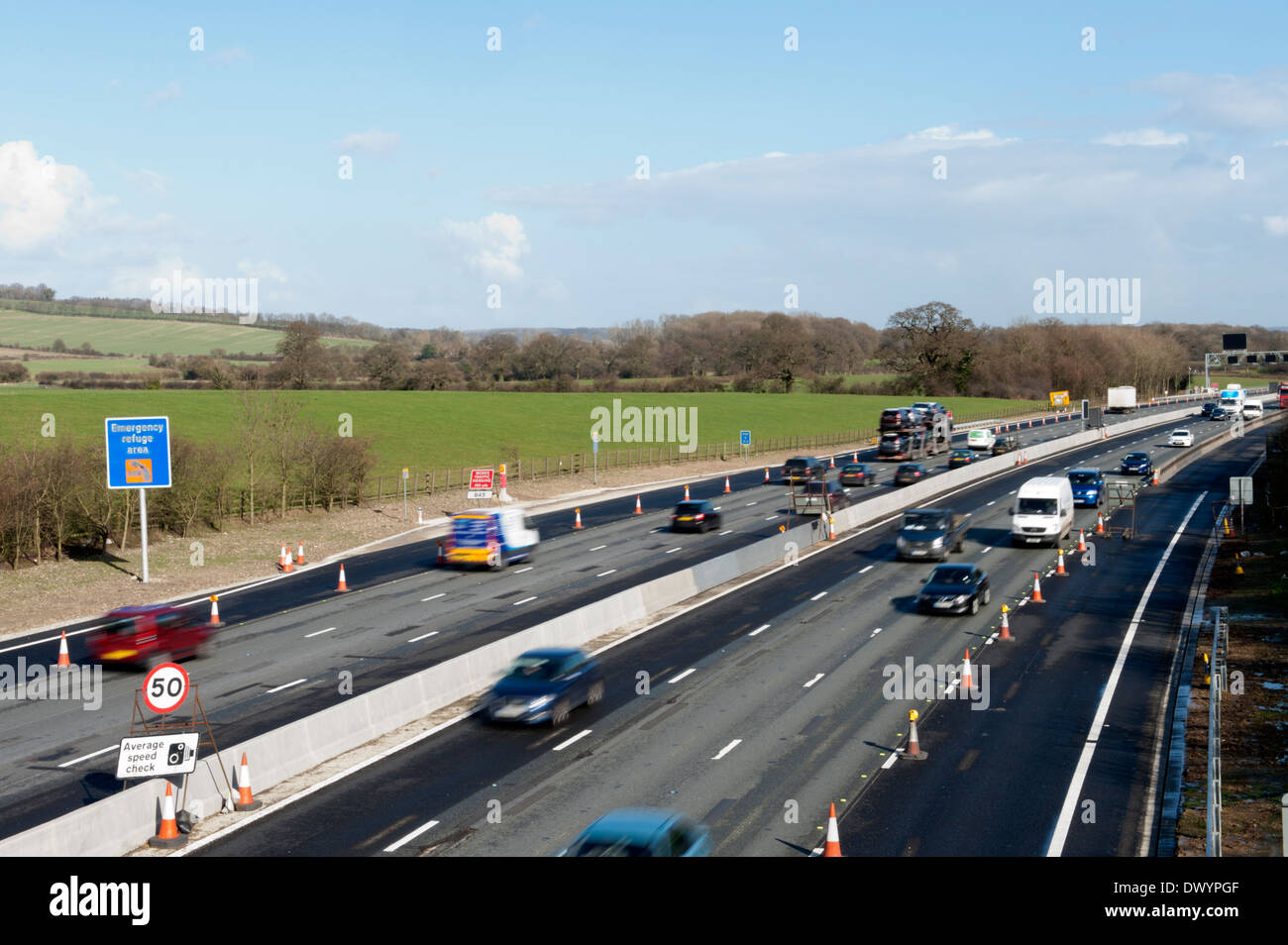 Traffic passing a coned off area on the M25 motorway in Surrey, UK ...