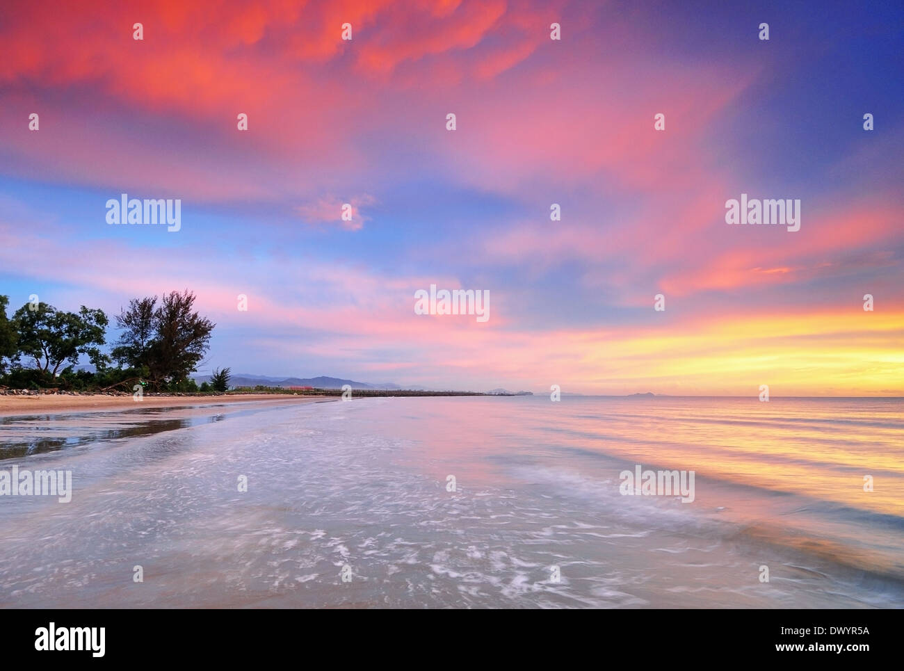 Tropical sunset and waves at the beach in Kota Kinabalu, Sabah, Borneo ...