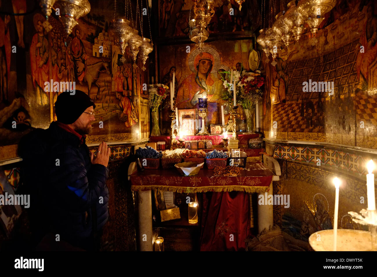 A Christian pilgrim prays inside the small Coptic Chapel which contains ...