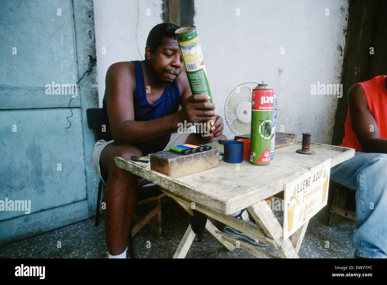 Man refilling disposable lighters with insect repellent Centro Havana ...