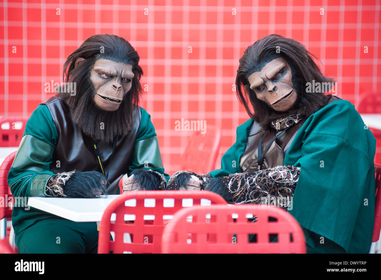 London, UK - 15 March 2014: two people dressed with apes costumes sits ...