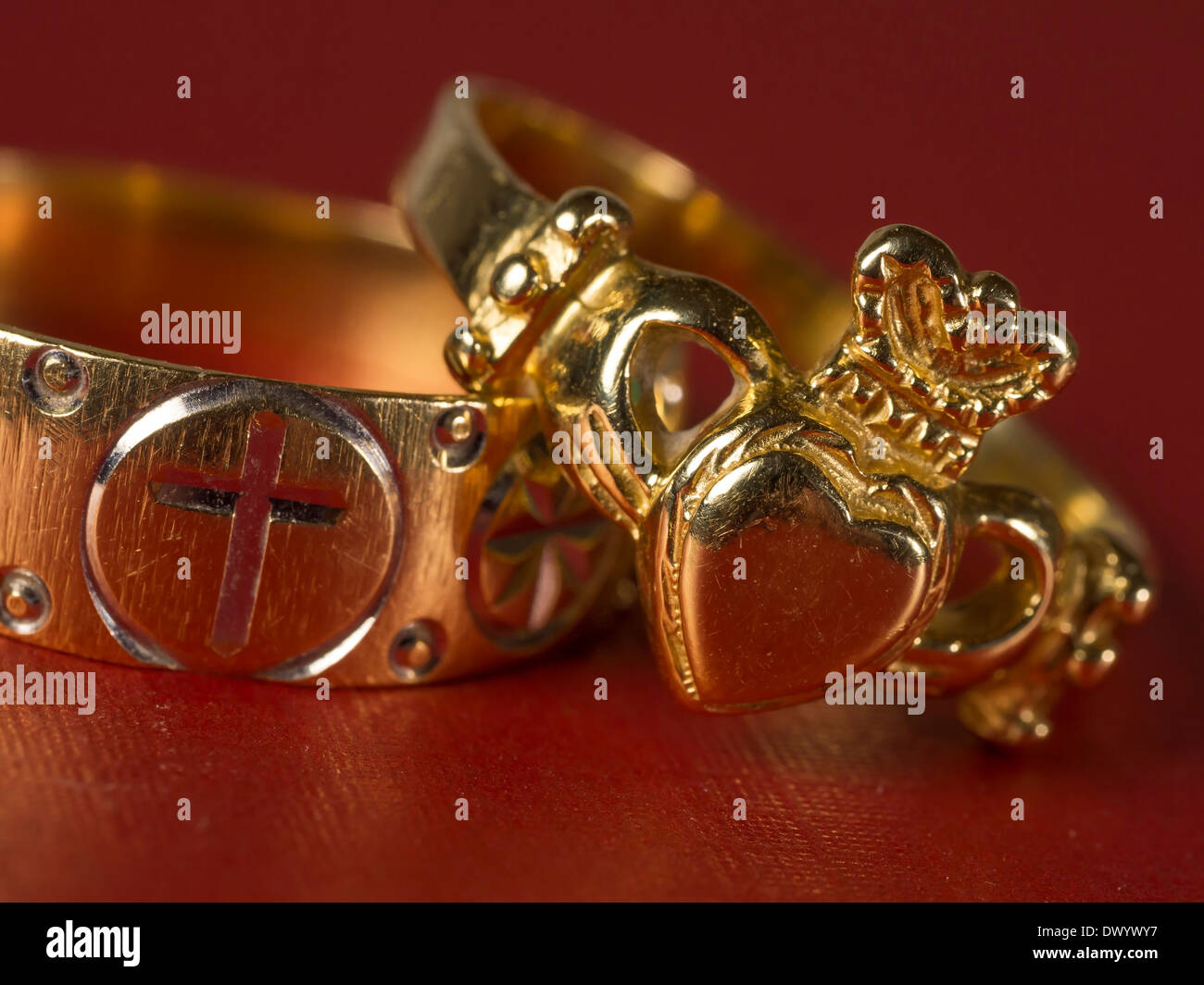 Two gold wedding rings, including a Claddagh ring with a crown Stock ...