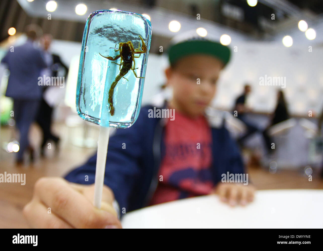 Hamburg, Germany. 15th Mar, 2014. A young visitor holds up a lollipop ...