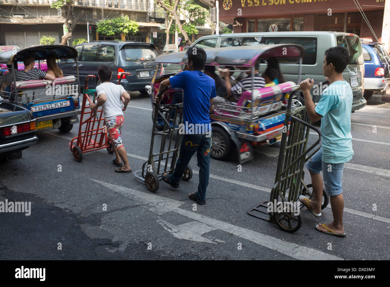 Three Men pushing Delivery Carts in Chinatown District Bangkok Stock ...