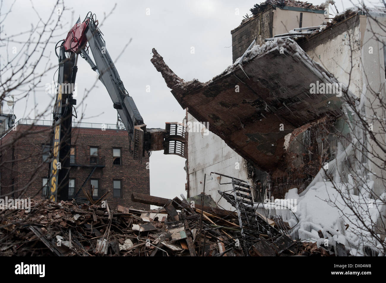 Manhattan, New York, USA. 14th Mar, 2014. Workers use a crane to clear ...