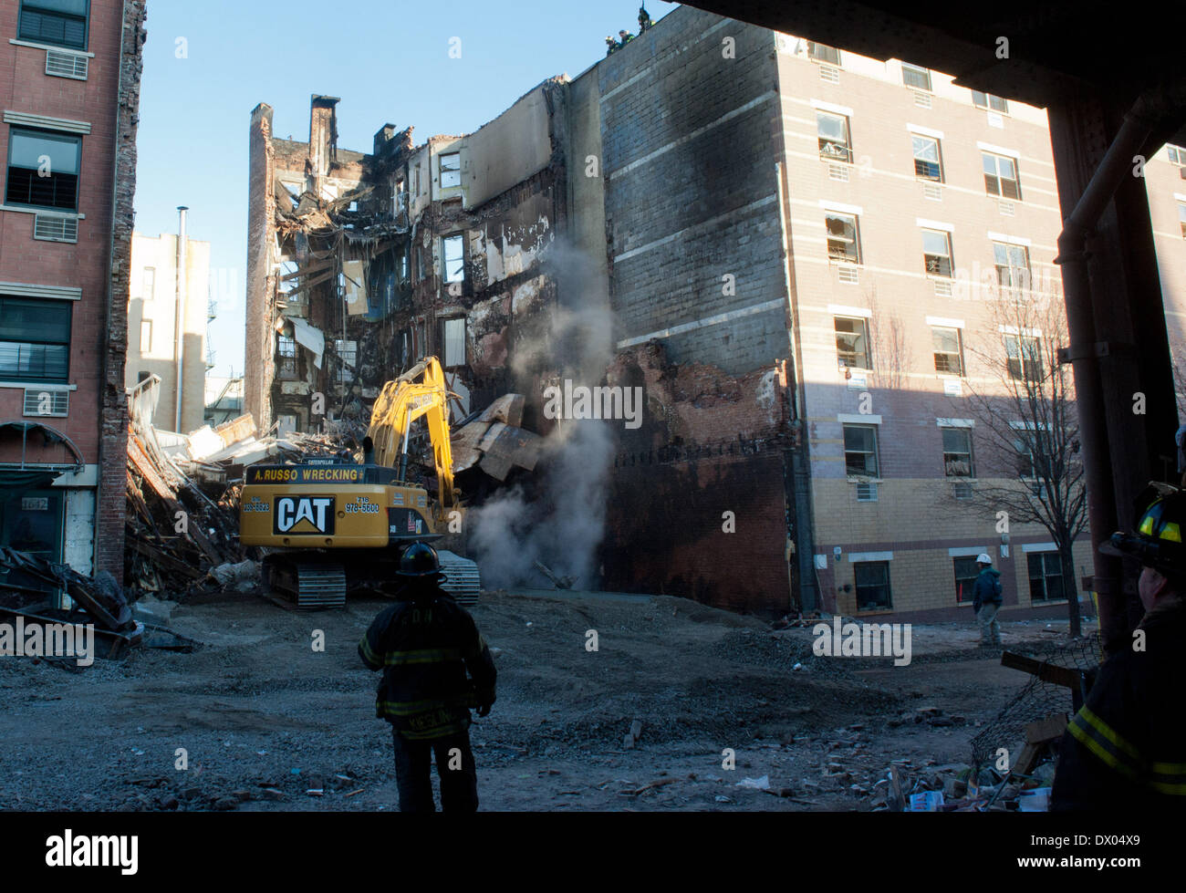 Manhattan, New York, USA. 14th Mar, 2014. Workers and firefighters ...