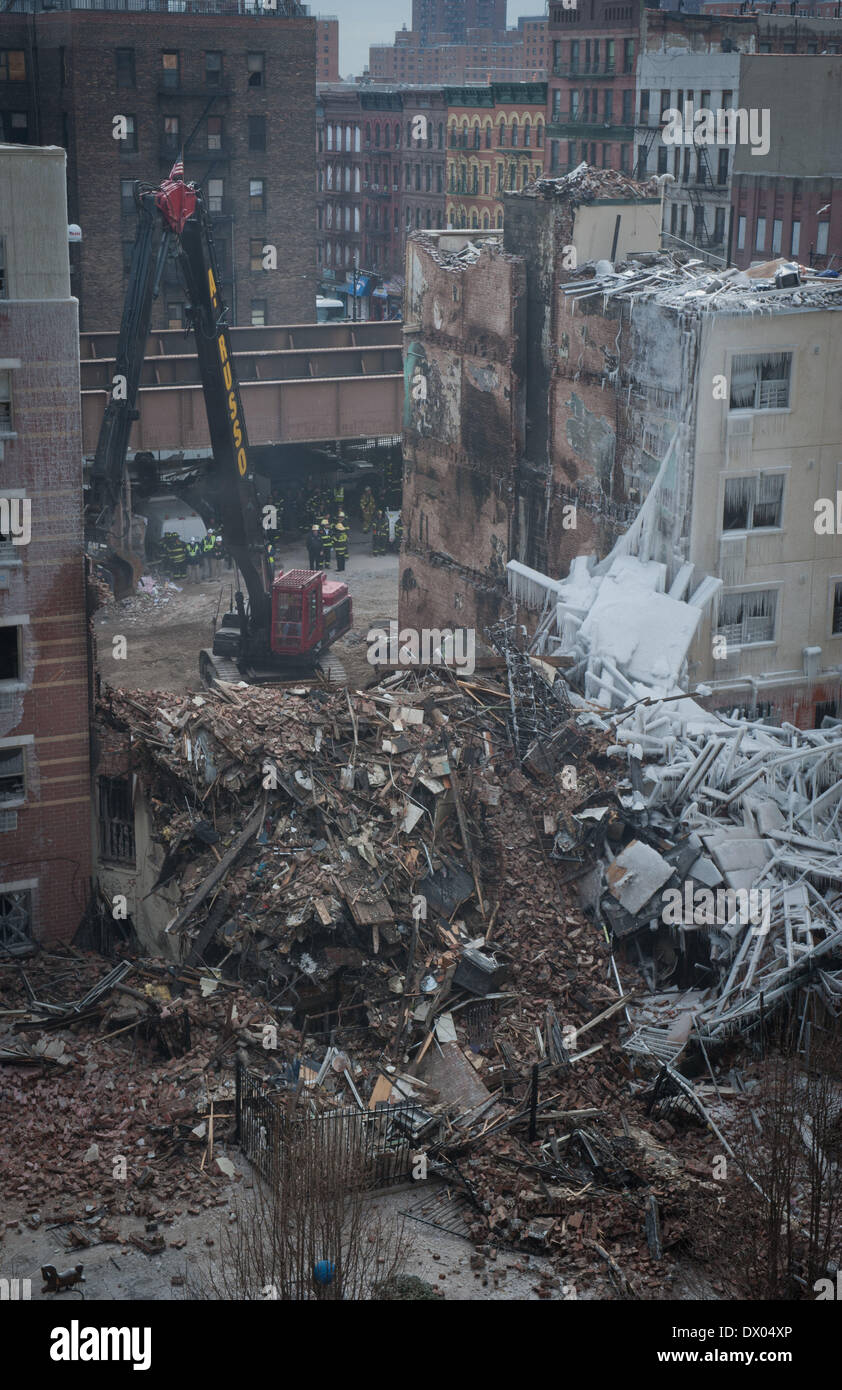 Manhattan, New York, USA. 14th Mar, 2014. Workers use a crane to clear ...