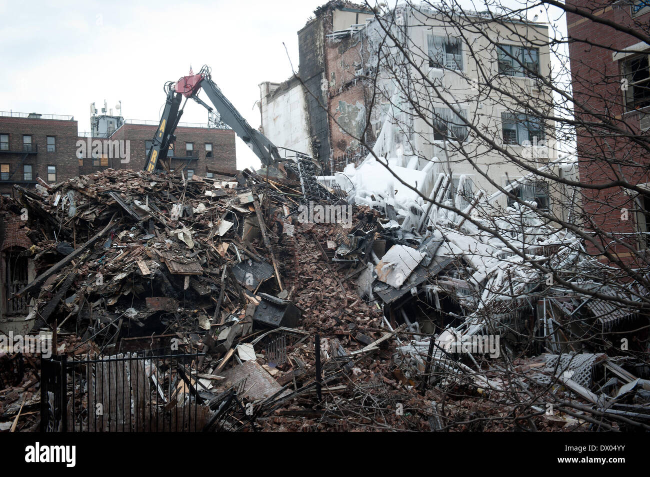 Manhattan, New York, USA. 14th Mar, 2014. Workers use a crane to clear ...
