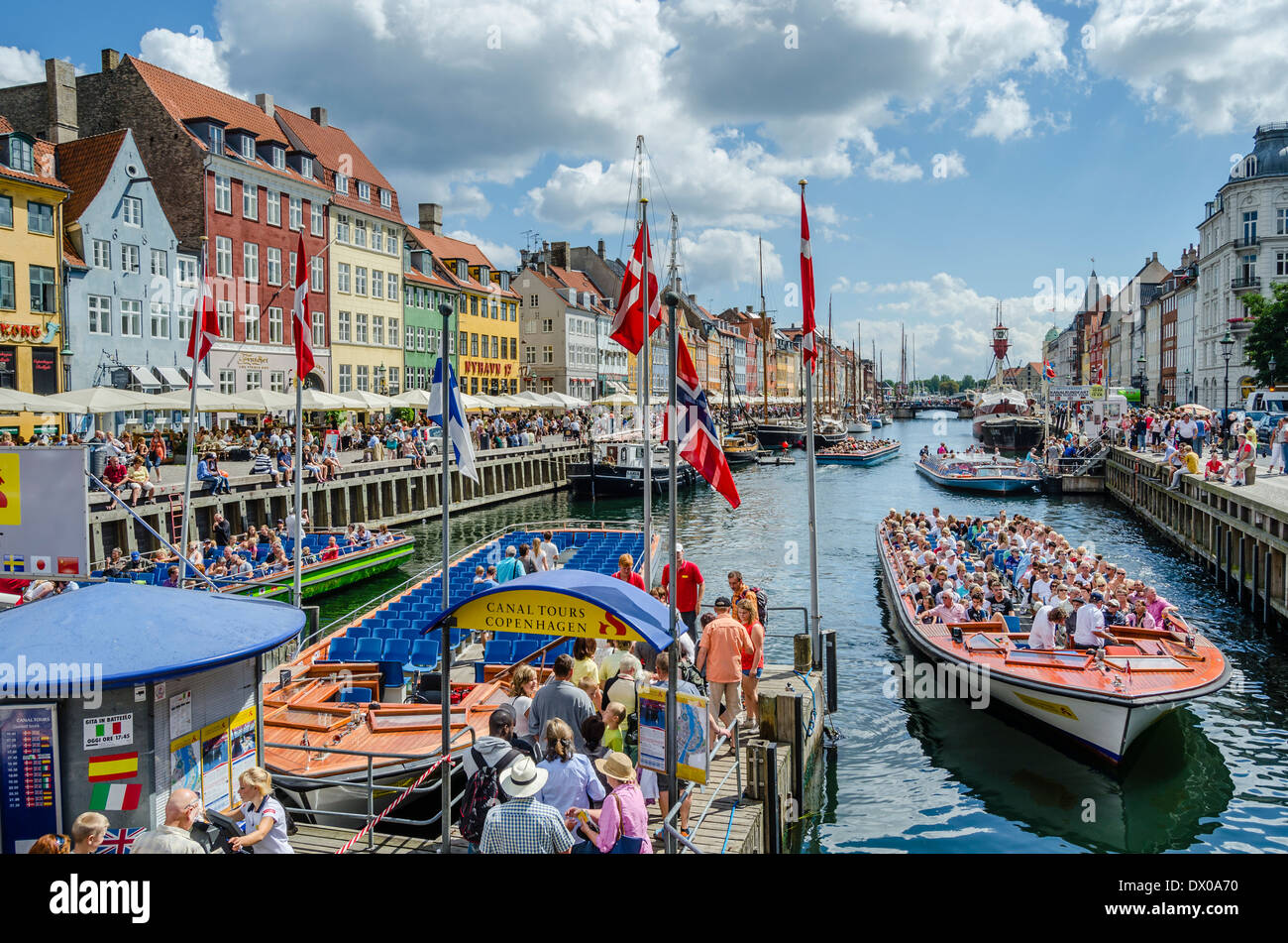 Tourist ships running through river at Nyhavn in Copenhagen, Denmark ...