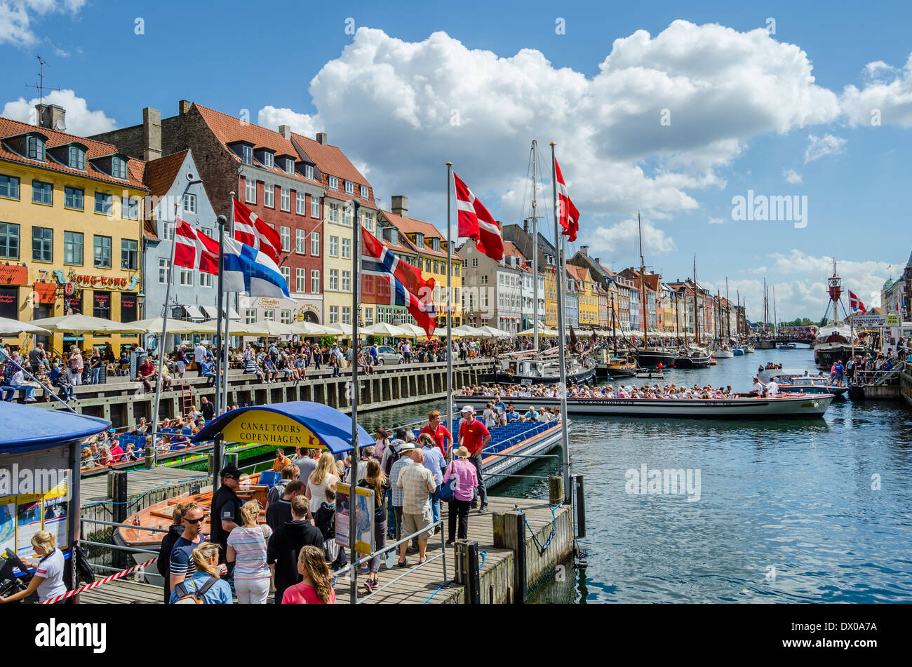 Tourist ships running through river at Nyhavn in Copenhagen, Denmark ...