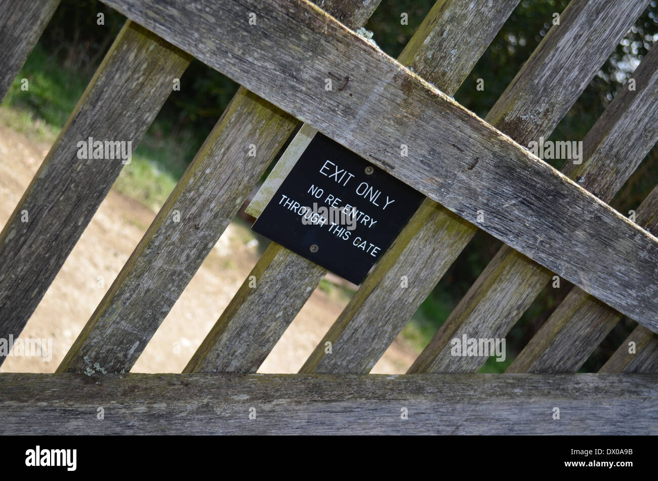 Exit only sign on closed wooden garden gate Stock Photo - Alamy
