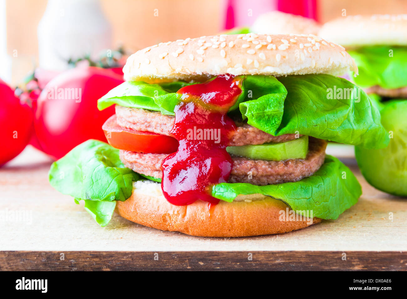 Appetizing big cheeseburger with fresh lettuce and cucumber Stock Photo ...