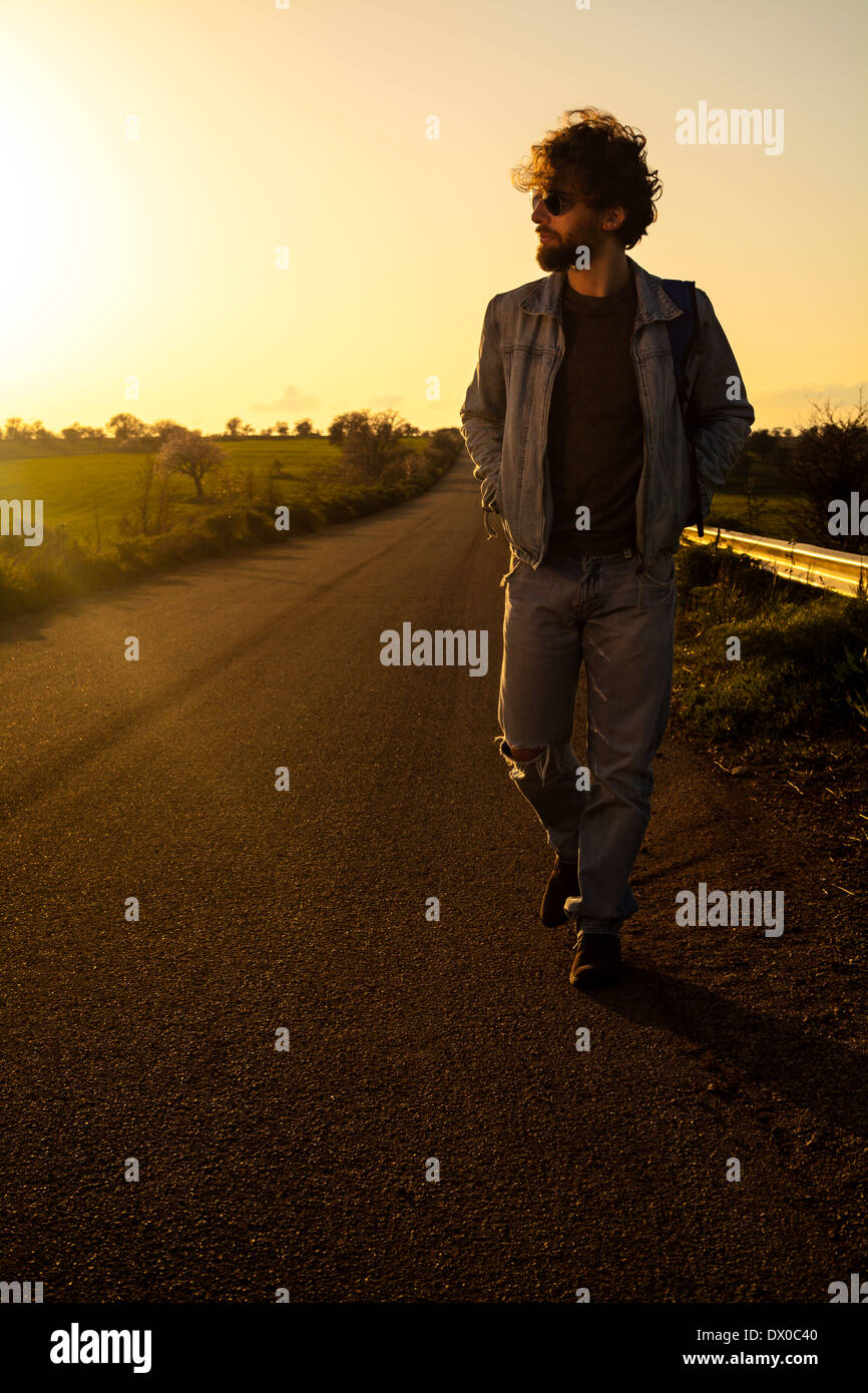 Man walking to sun road hi-res stock photography and images - Alamy